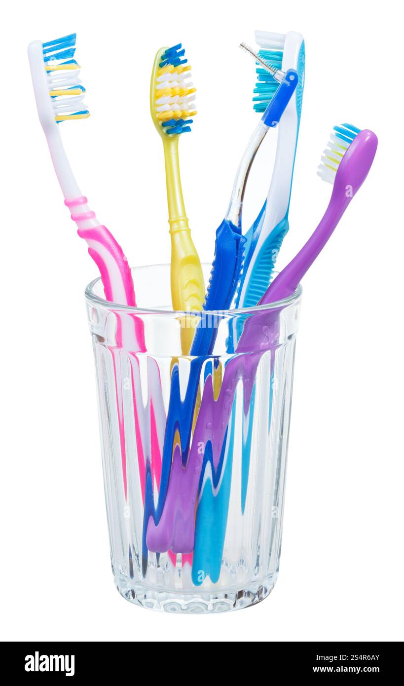 four toothbrushes and interdental brush in glass - family set of ...