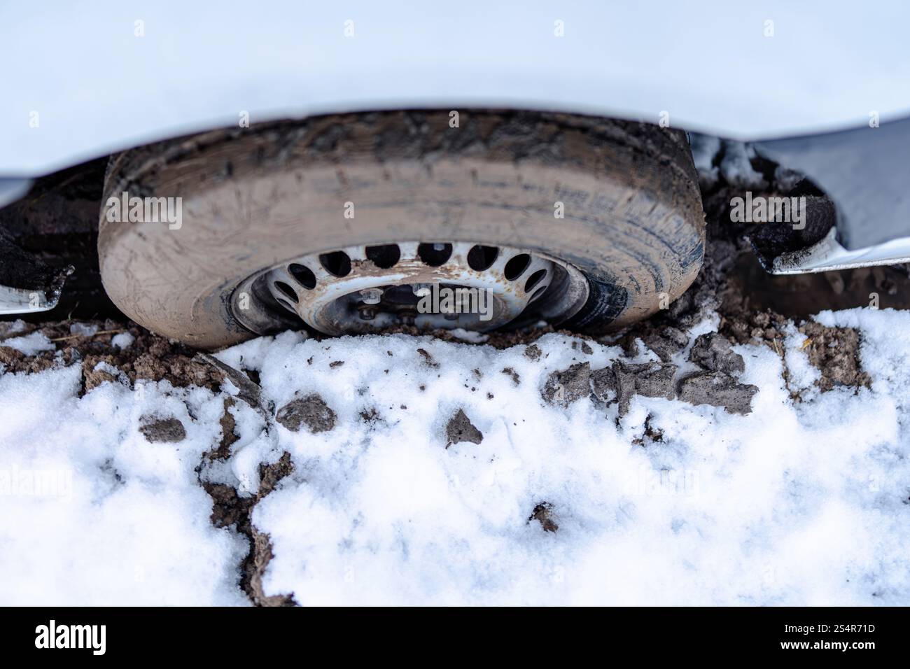 Wheels are stuck in muddy snow on a very cold day Stock Photo - Alamy