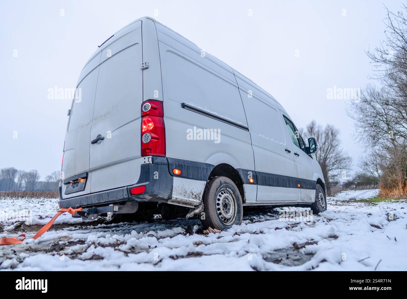 Transporter stuck in snow during winter getting help Stock Photo - Alamy