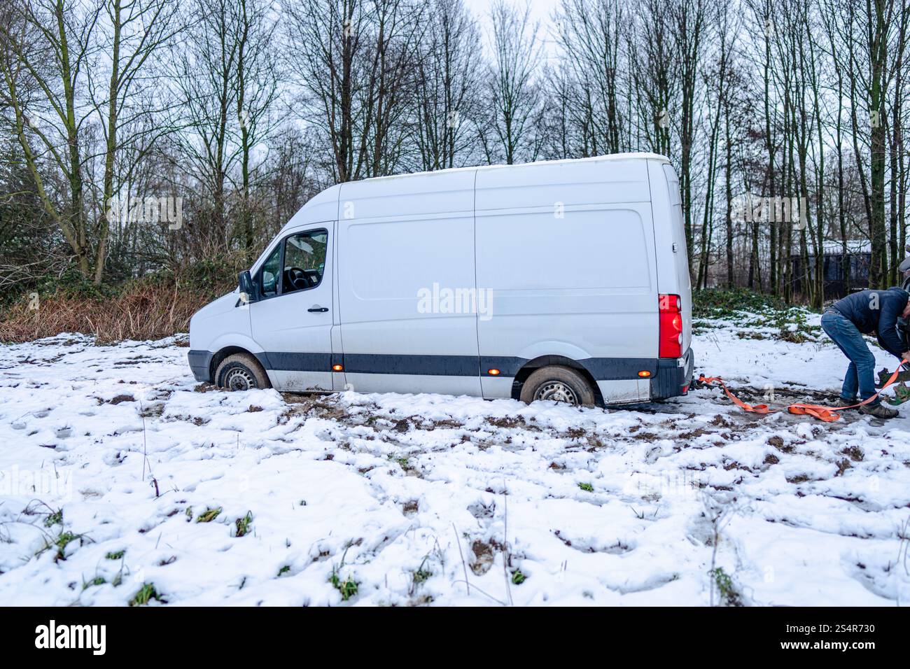 Transporter stuck in snow during winter getting help Stock Photo - Alamy