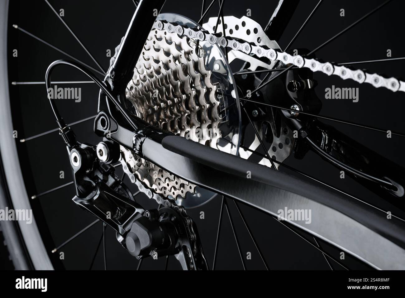 Shifting gears on rear transmission of bicycle on black background ...