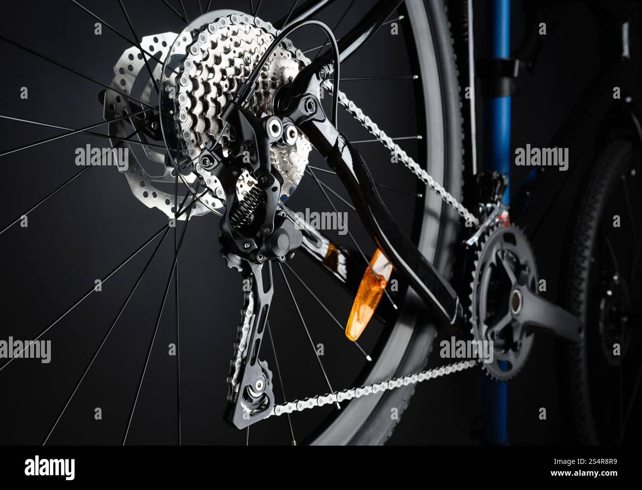 Rear wheel of bicycle, shifter, sprocket cassette, and chain. Rear view ...