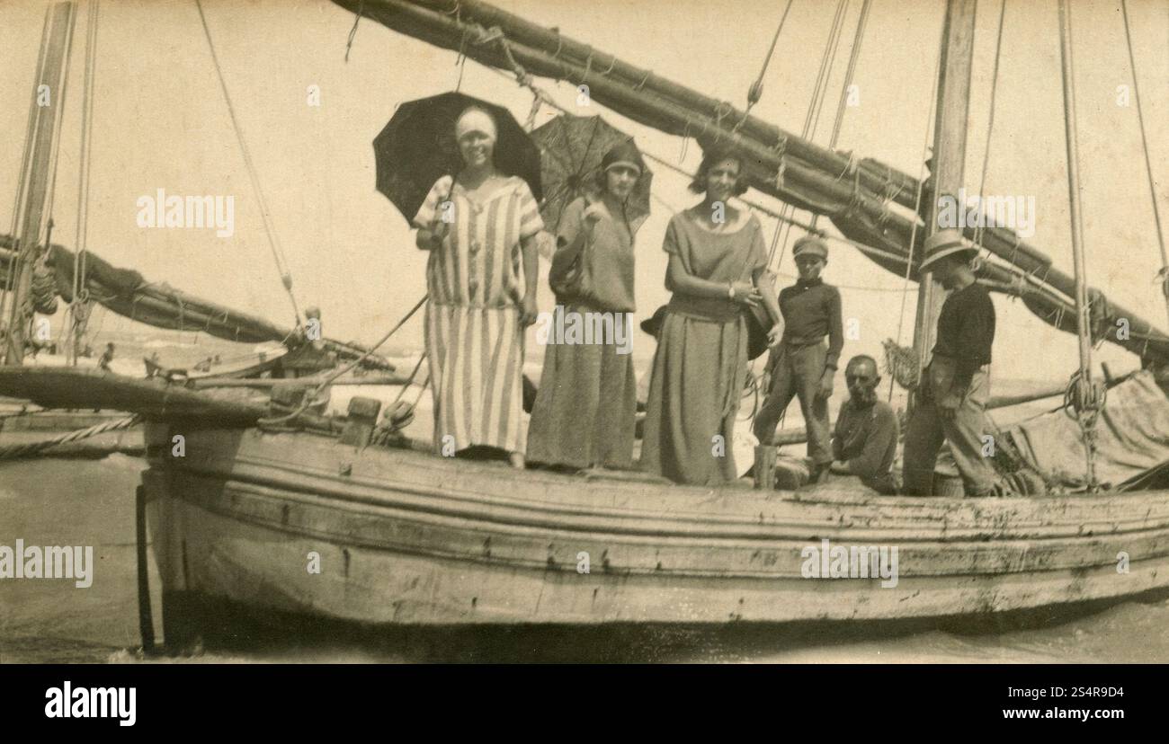 Women on a boat with sun umbrellas, Italy 1920s Stock Photo - Alamy