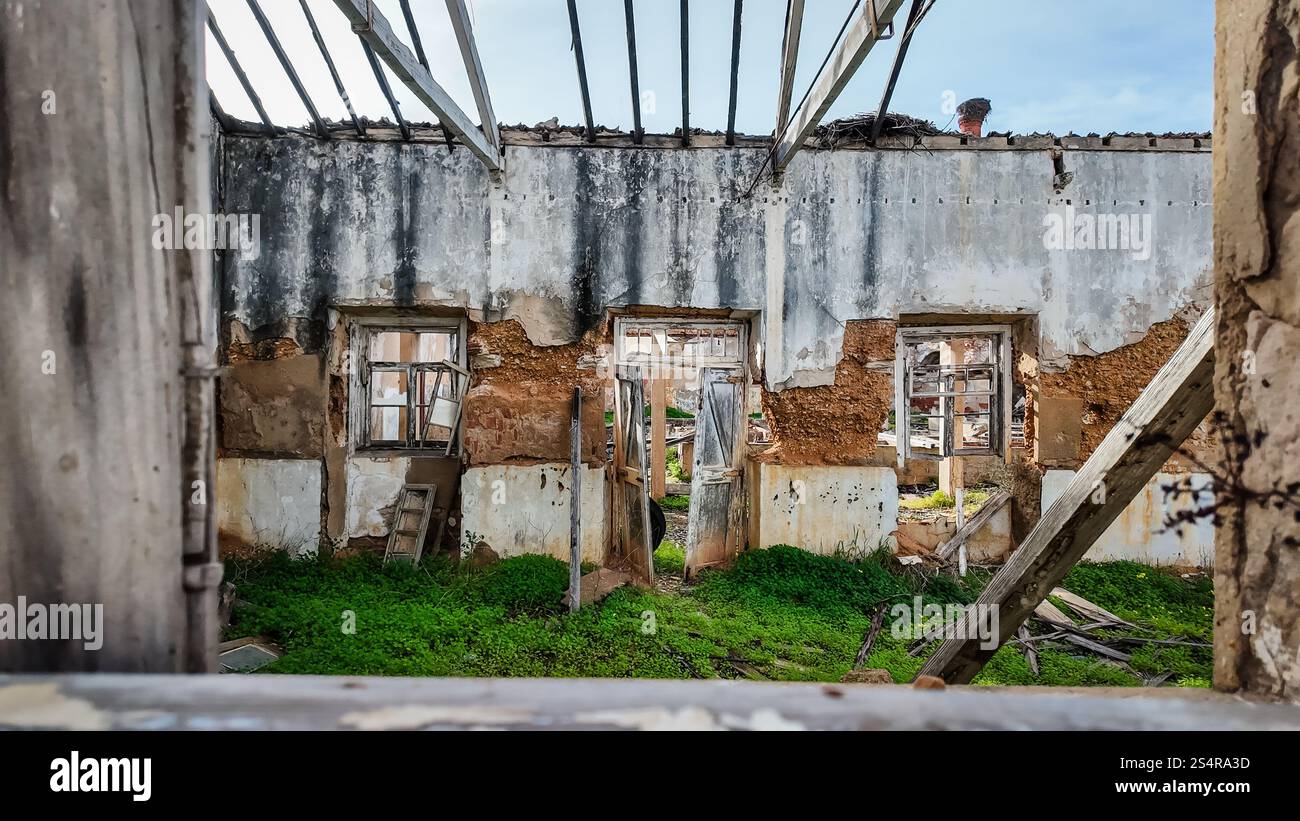 The interior of an abandoned house with no roof, exposing the remnants ...