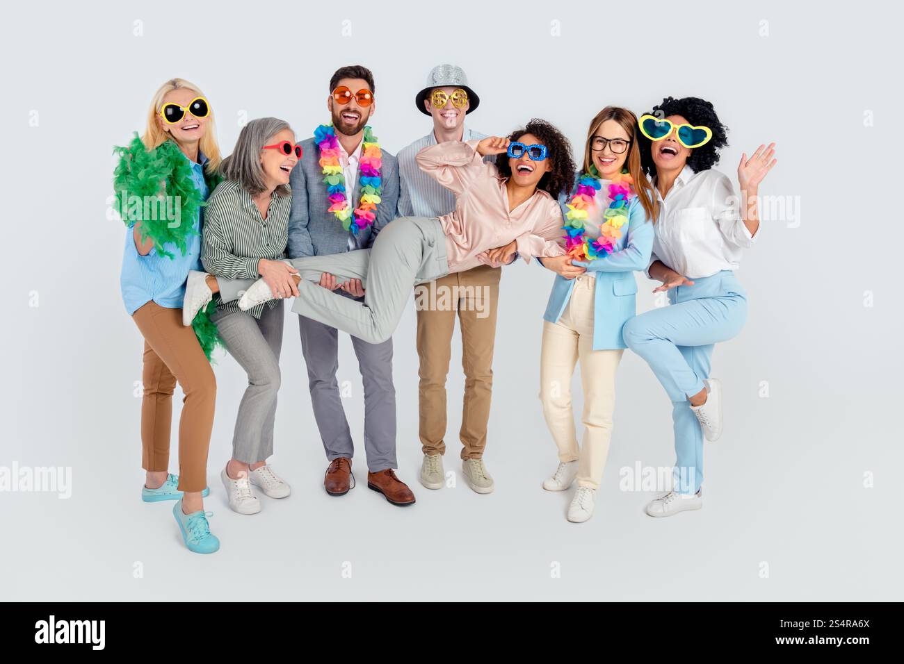 Diverse group of cheerful business professionals celebrating teamwork ...