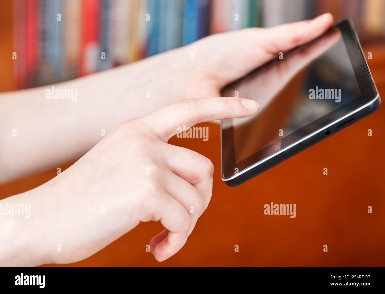 finger clicking touchpad screen in library room Stock Photo - Alamy