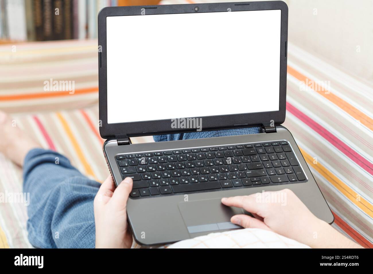 man read on laptop with cut out screen in living room Stock Photo - Alamy