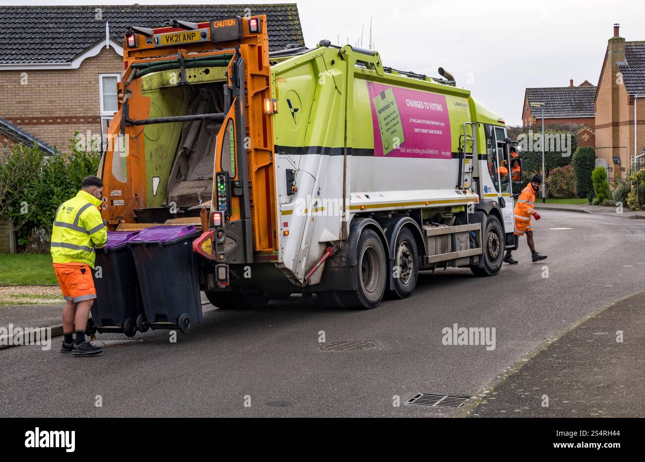 Waste bin being placed on carriers to be emptied into lorry, Cherry ...