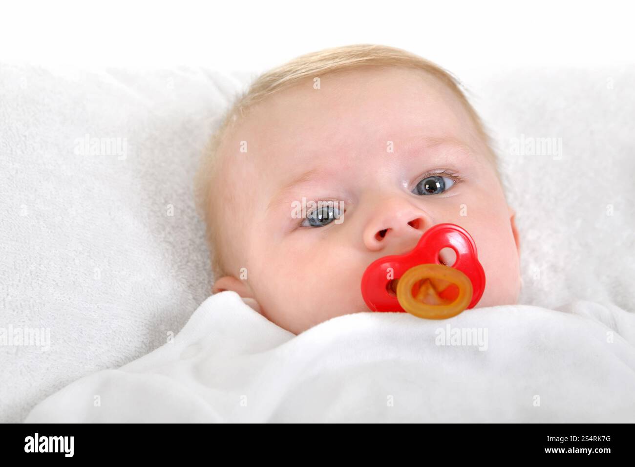 Baby Boy with pacifier lying on the White blanket Stock Photo - Alamy