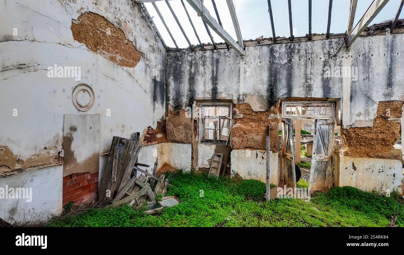 The interior of an abandoned house with no roof, exposing the remnants ...