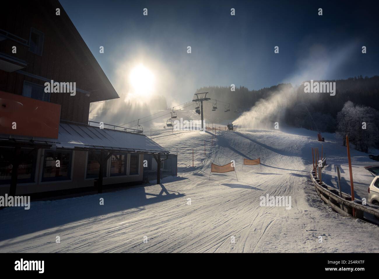 Covered by snow traditional hotel in Austrian Alps at the mountain foot ...