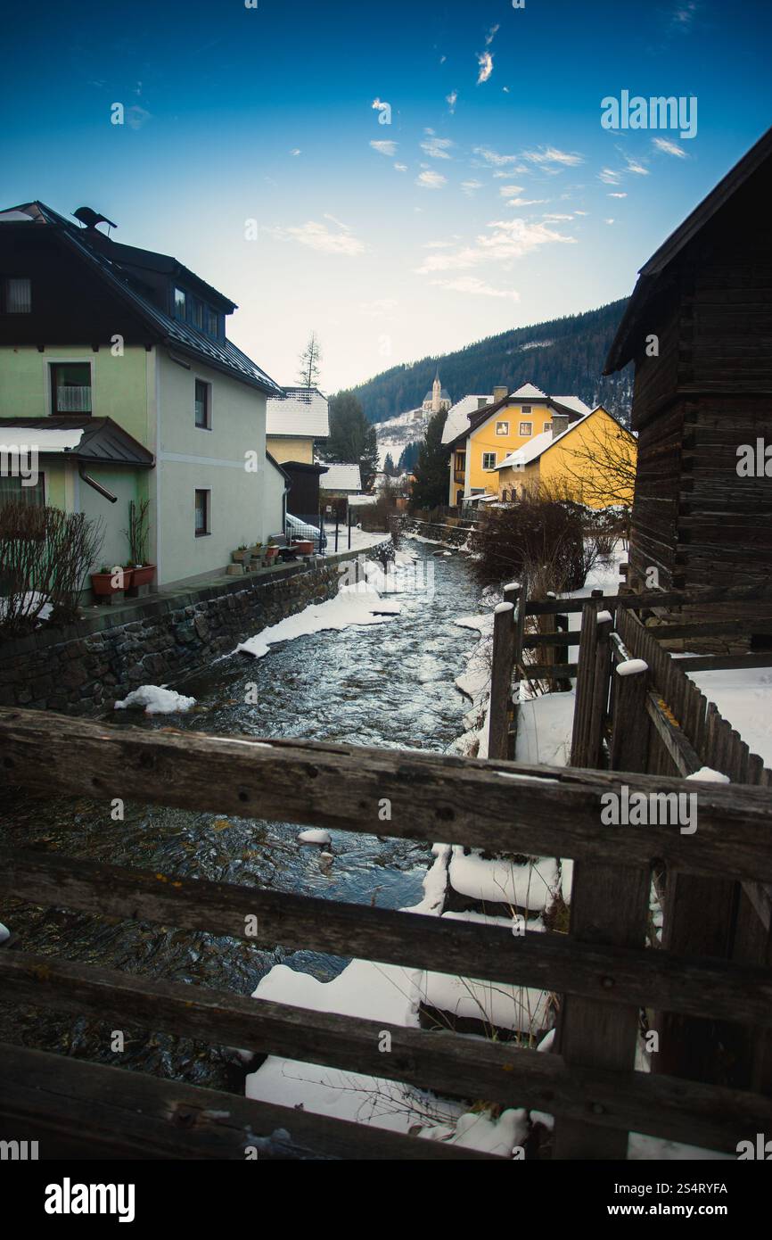 Fast mountain river going through old medieval town at Austrian alps ...