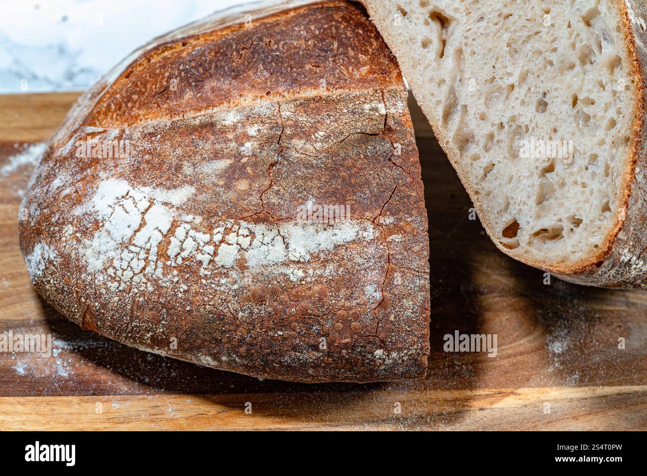 Freshly sliced homemade bread made from whole-grain sourdough flour ...