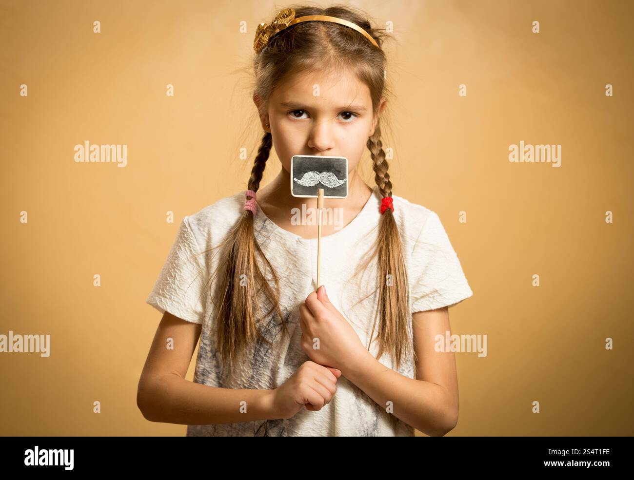 Little cute girl holding funny decorative mustaches Stock Photo - Alamy