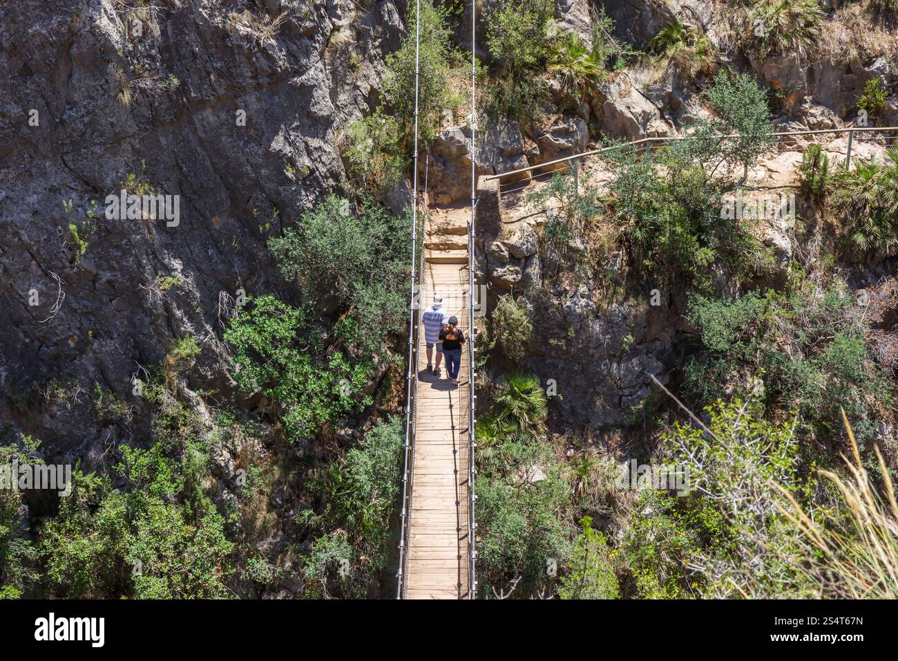 People crossing the suspension bridge near Chulilla, Spain Stock Photo ...