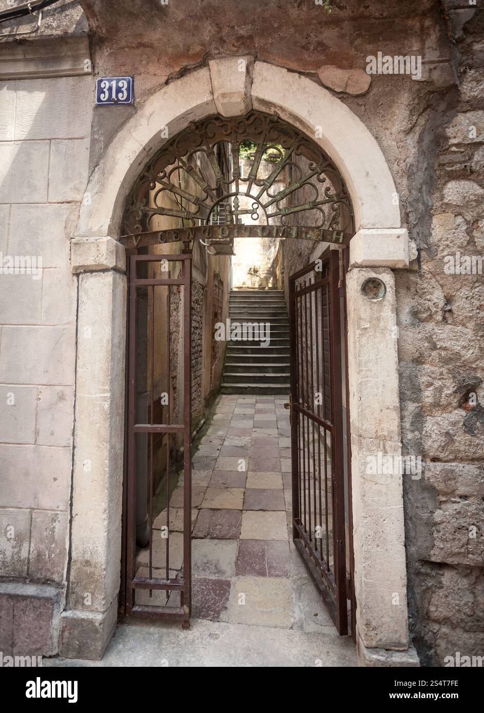Old rusty forged gates on street of old town Stock Photo - Alamy