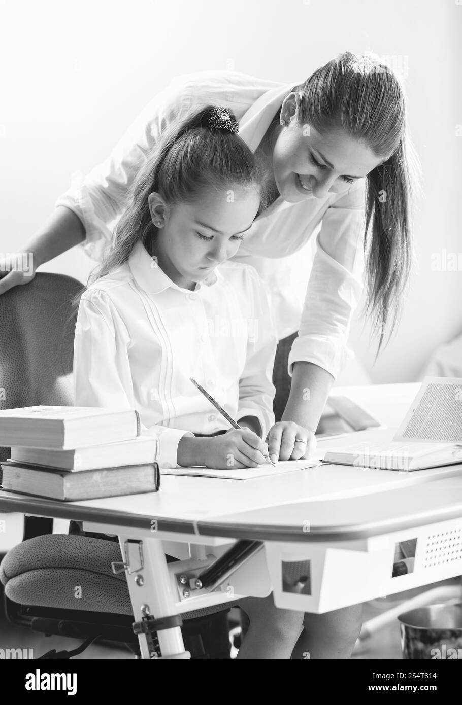 Black and white portrait of mother doing homework with daughter Stock ...