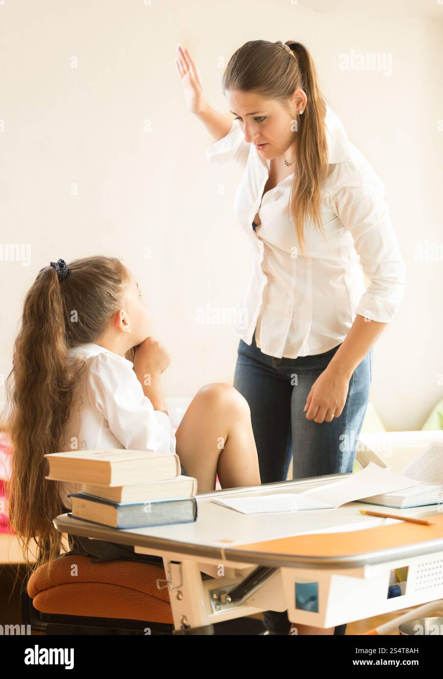 Portrait of angry mother hitting intimidated daughter Stock Photo - Alamy