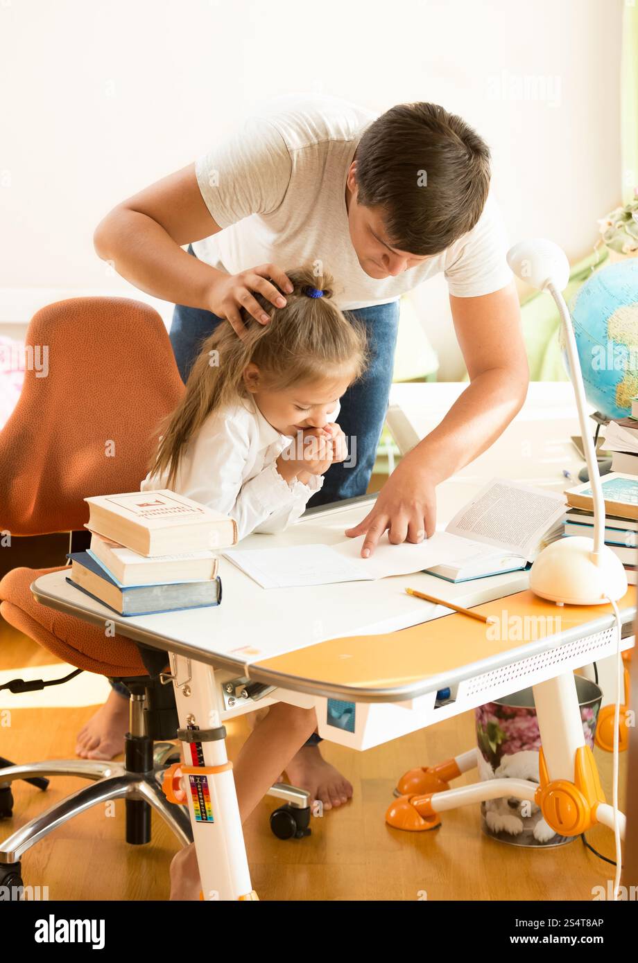 Young father angry at daughter doing homework Stock Photo - Alamy