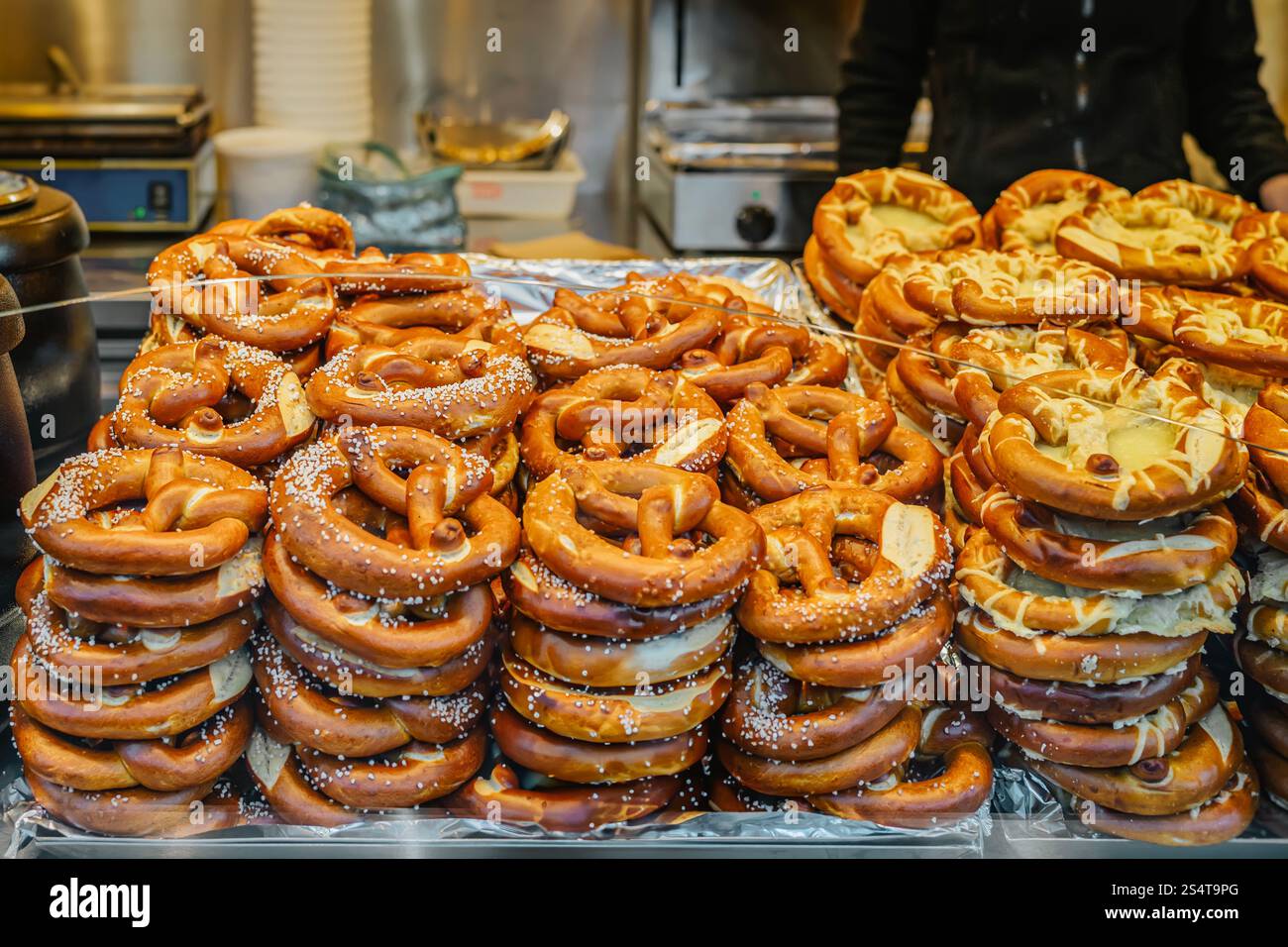 Freshly baked pretzels on display at market stall. Concept of ...