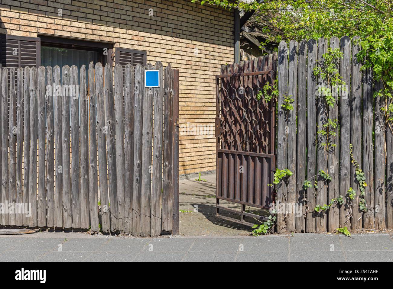 Weathered Wood Logs Fence With Open Gate House Entrance Stock Photo - Alamy