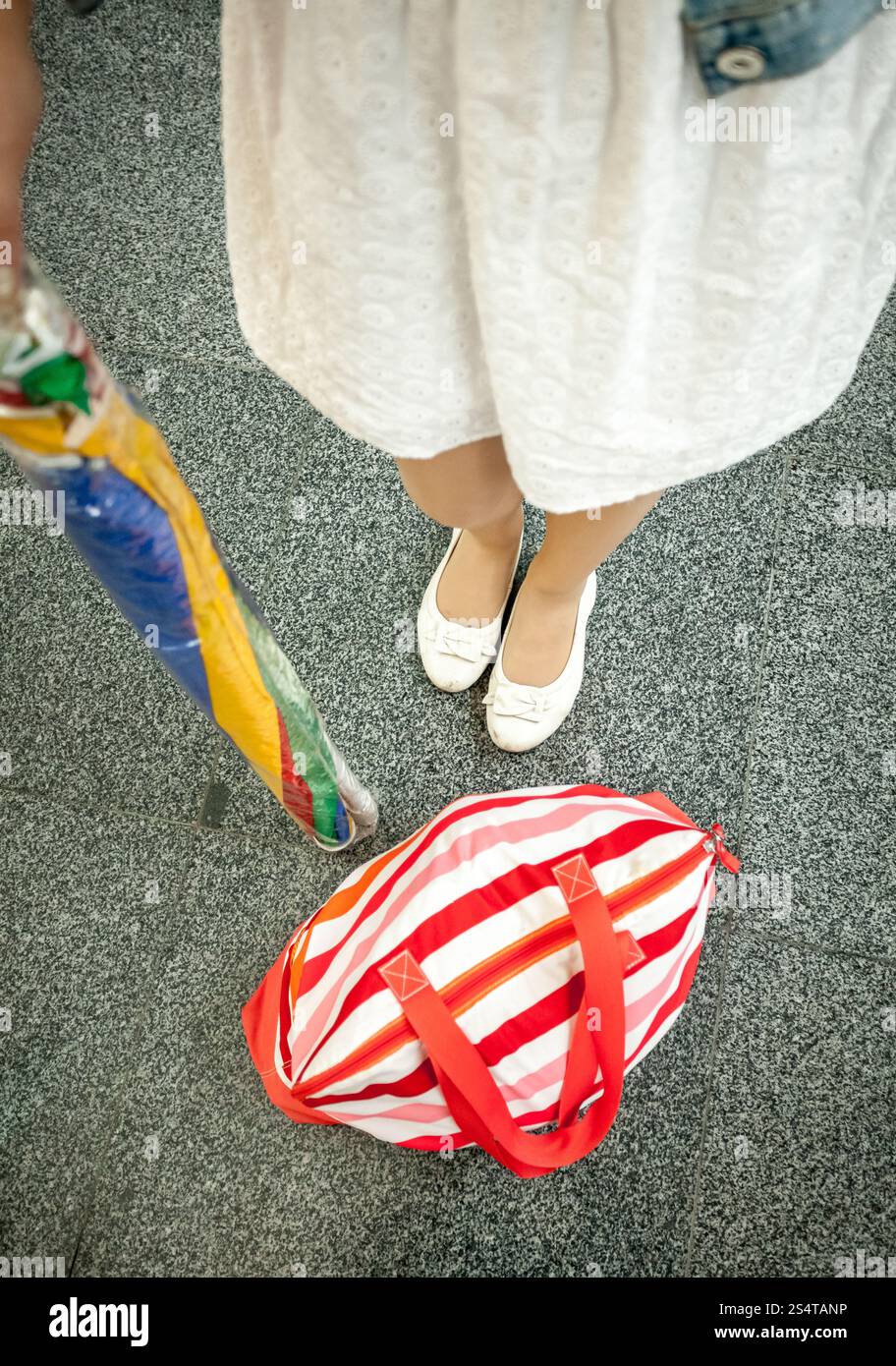 Closeup photo of female feet, sun umbrella and beach bag Stock Photo ...
