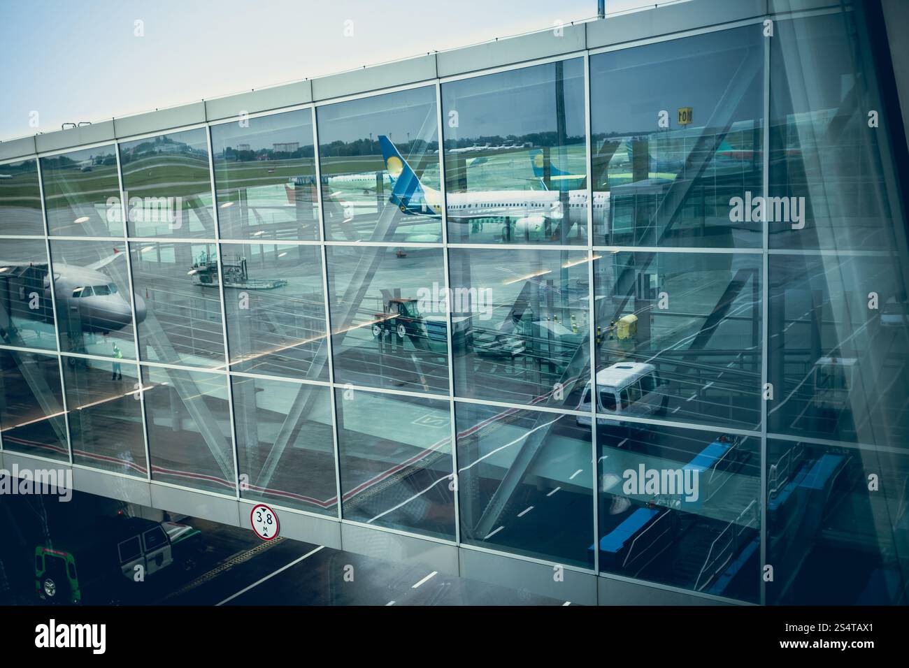 Big airliner reflecting in glass wall of modern airport terminal Stock ...