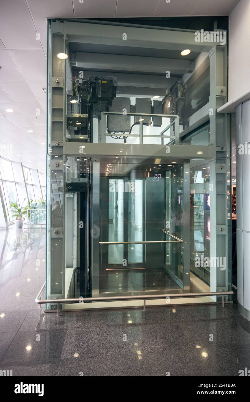 Interior shot of glass elevator at airport terminal Stock Photo - Alamy