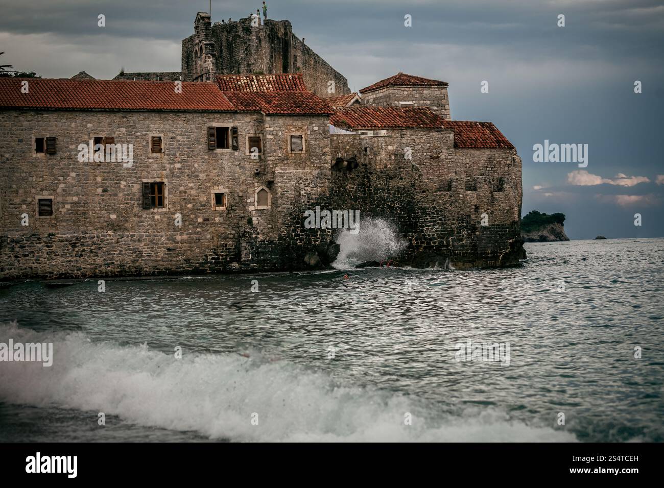 Old stone citadel on high cliff at late evening in stormy sea Stock ...