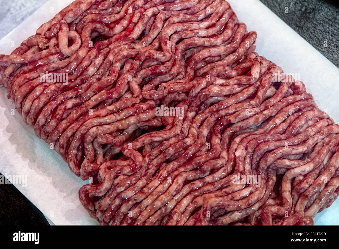 Fresh raw minced meat on paper, pork, beef, forcemeat close-up isolated ...