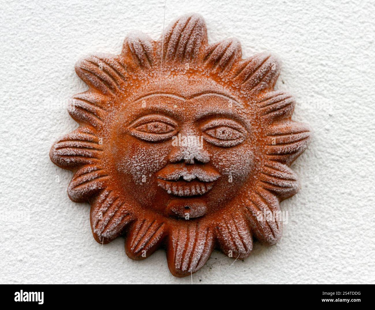 frost on terracotta sun face Stock Photo - Alamy