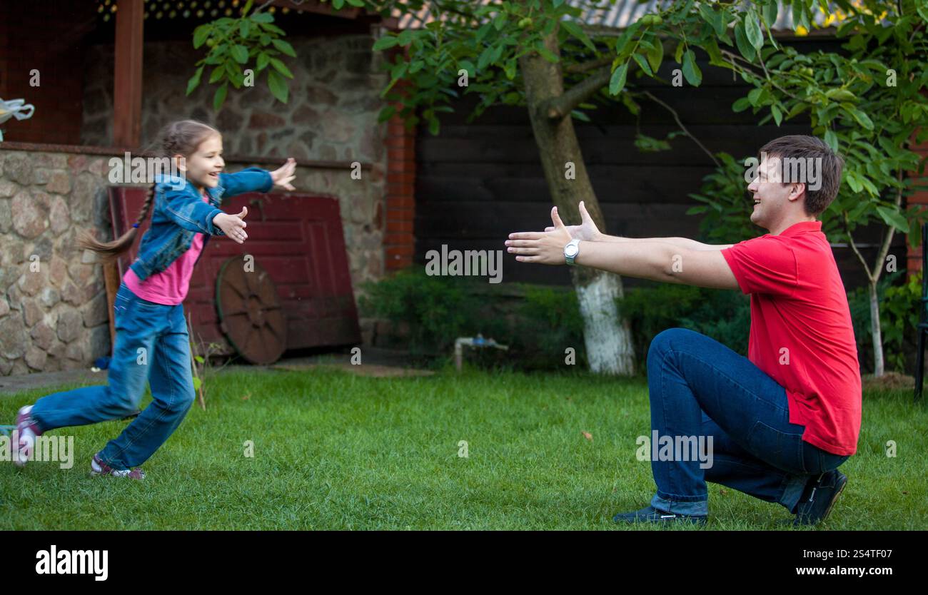 Happy daughter running at father to hug him at park Stock Photo - Alamy