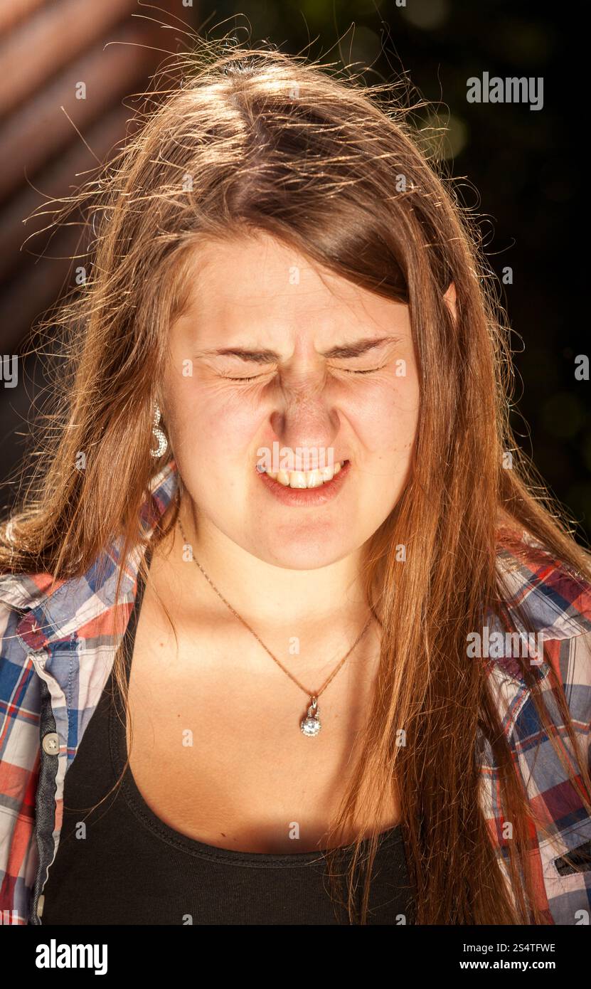 Closeup portrait of brunette woman wincing of bright light Stock Photo ...