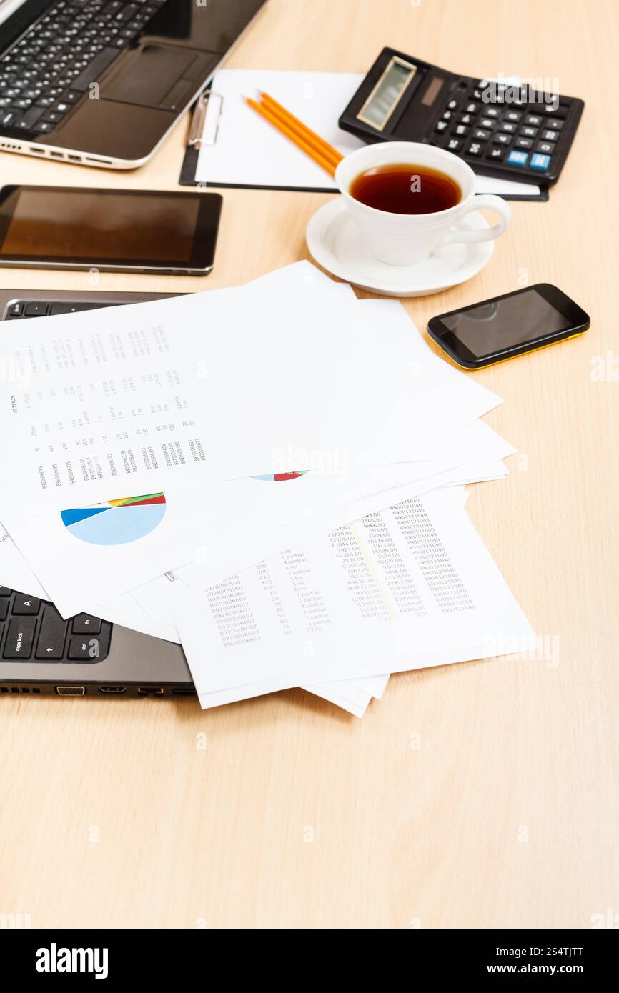 business workflow - paper charts and modern office tools on table Stock ...