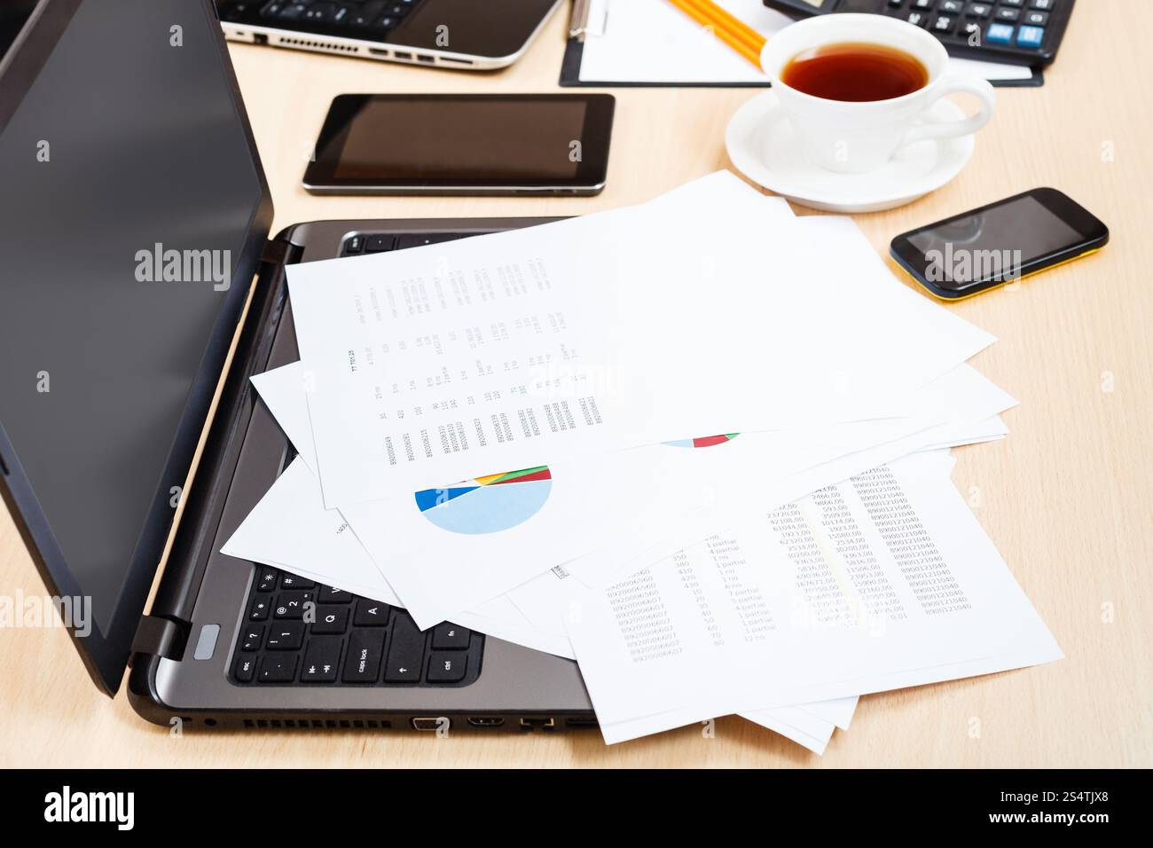 business workflow - paper charts and modern office tools on desk Stock ...