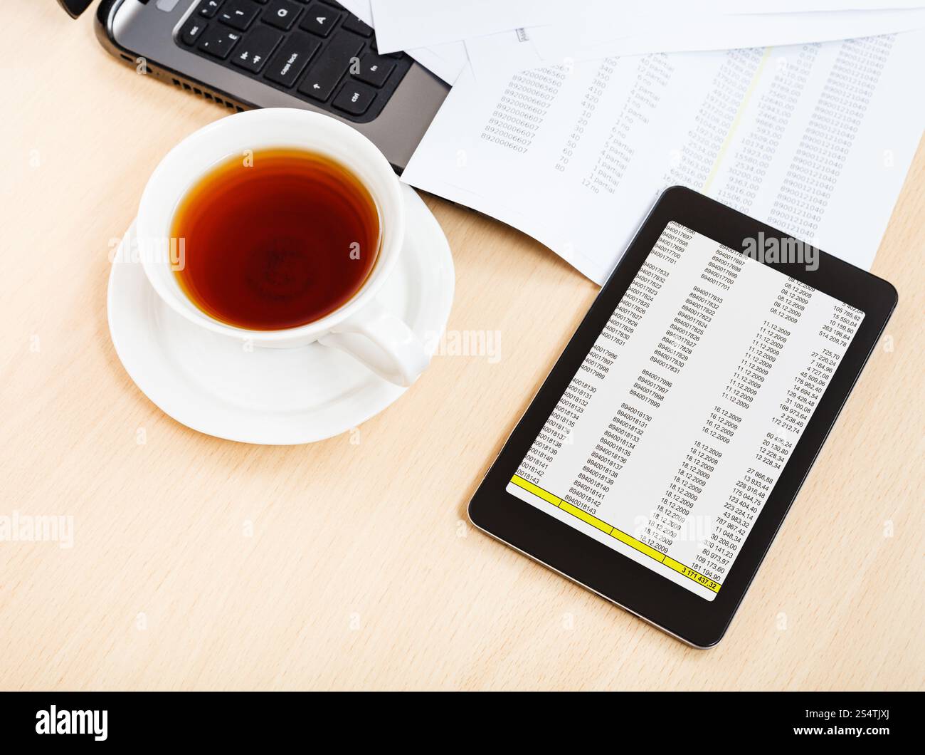 business workflow - above view cup of tea and tablet pc on office desk ...
