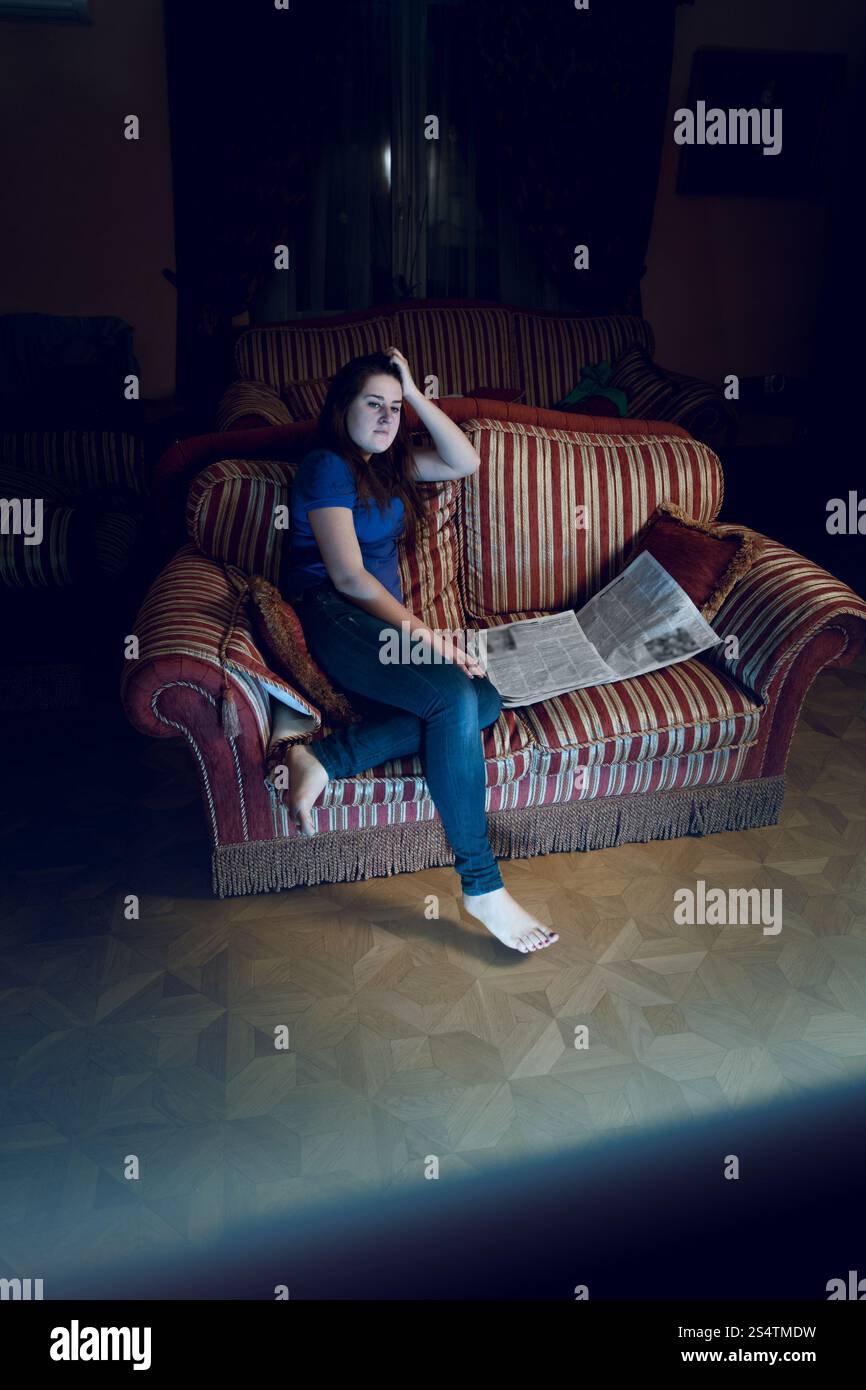 Beautiful woman watching TV show at late night Stock Photo - Alamy