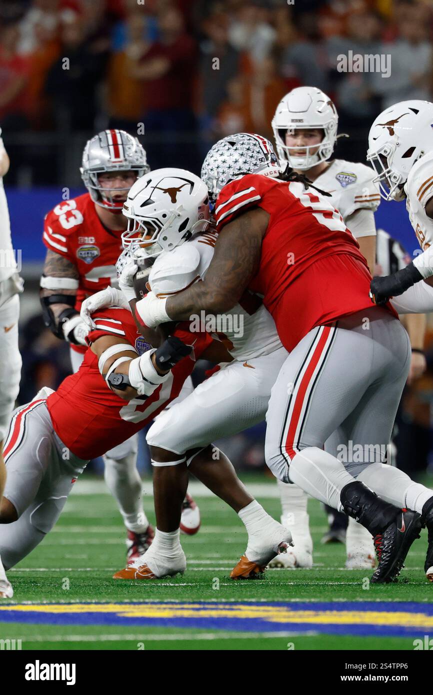 Texas running back Quintrevion Wisner (26) gets wrapped up by defenders ...