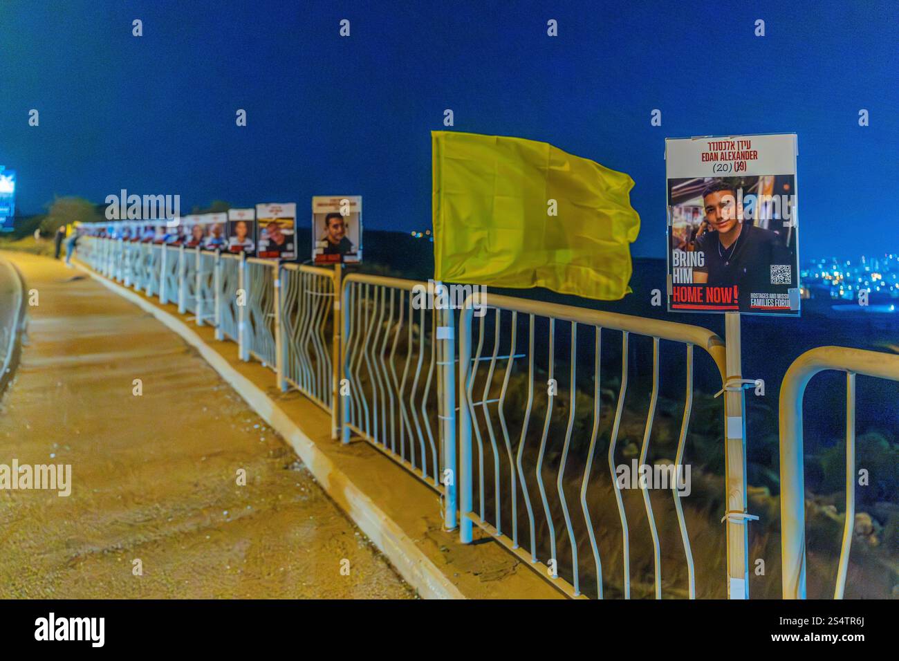 Haifa, Israel - January 12, 2025: People hang and maintain posters of ...