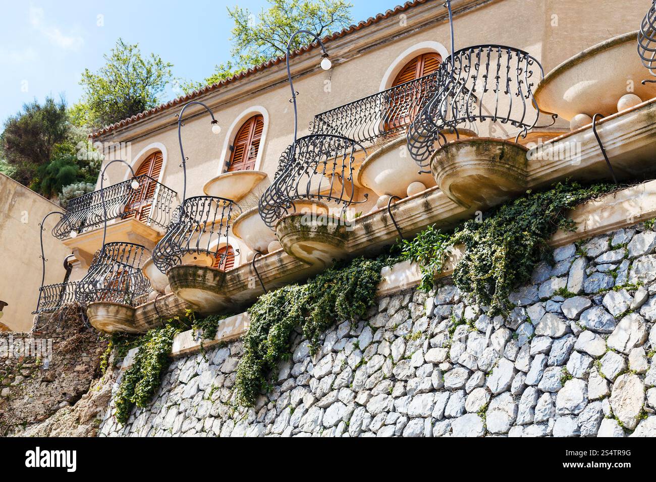 stone wall and urban house in Savoca town, Sicily, Italy Stock Photo ...