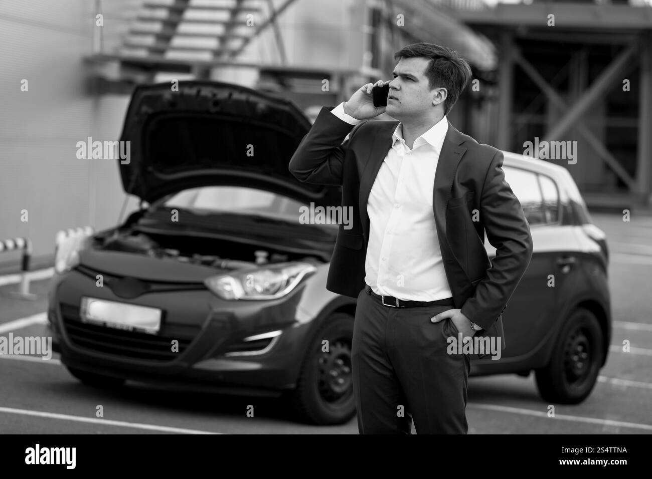 Black and white portrait of man calling in technical service to ...