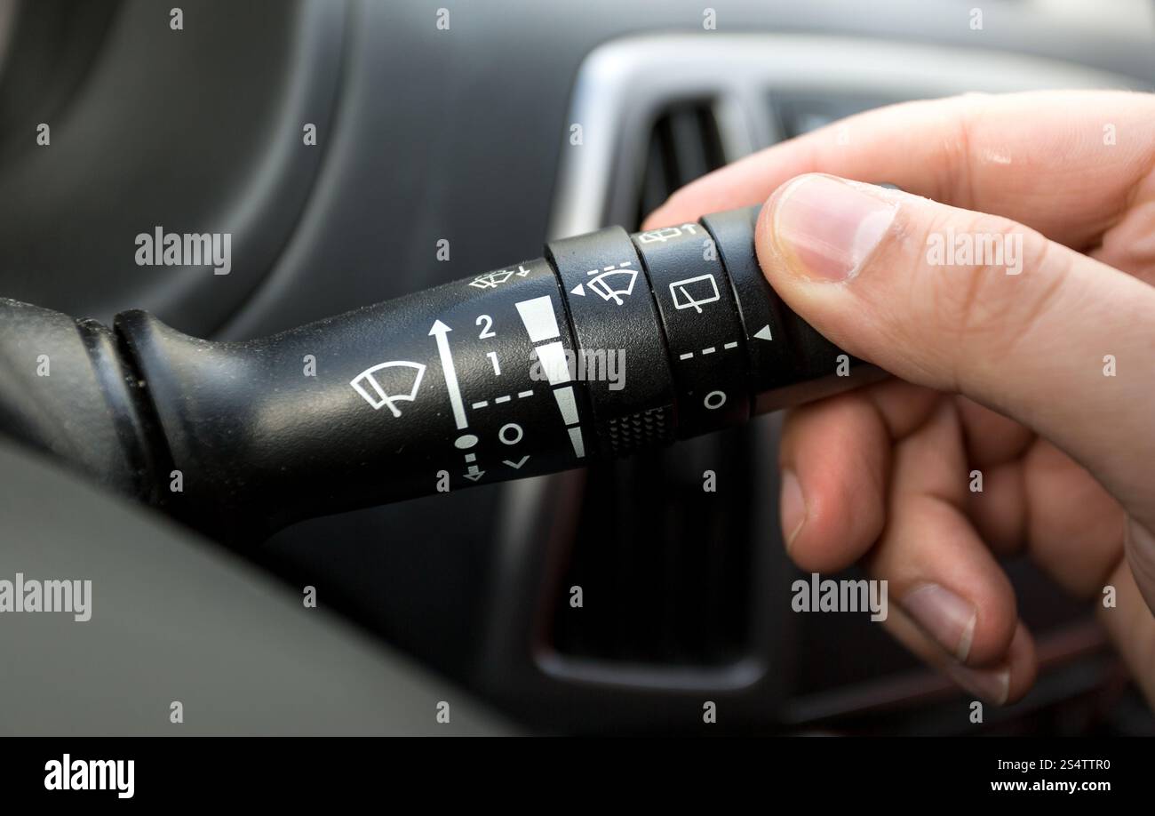 Macro photo of driver adjusting windscreen wipers control toggle Stock ...