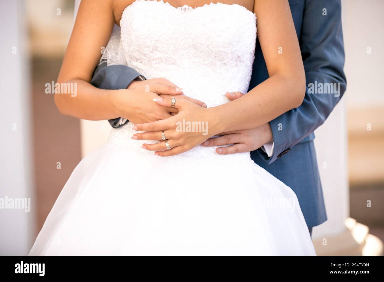 Closeup photo of groom hugging slim young bride from back Stock Photo ...
