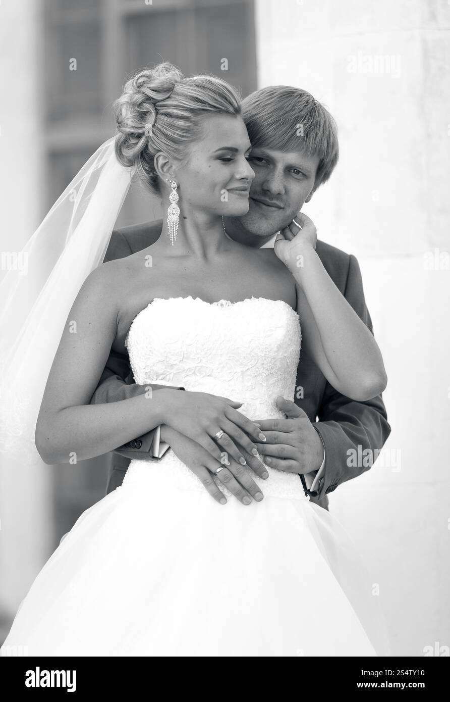 Closeup black and white portrait of beautiful bride and groom hugging ...