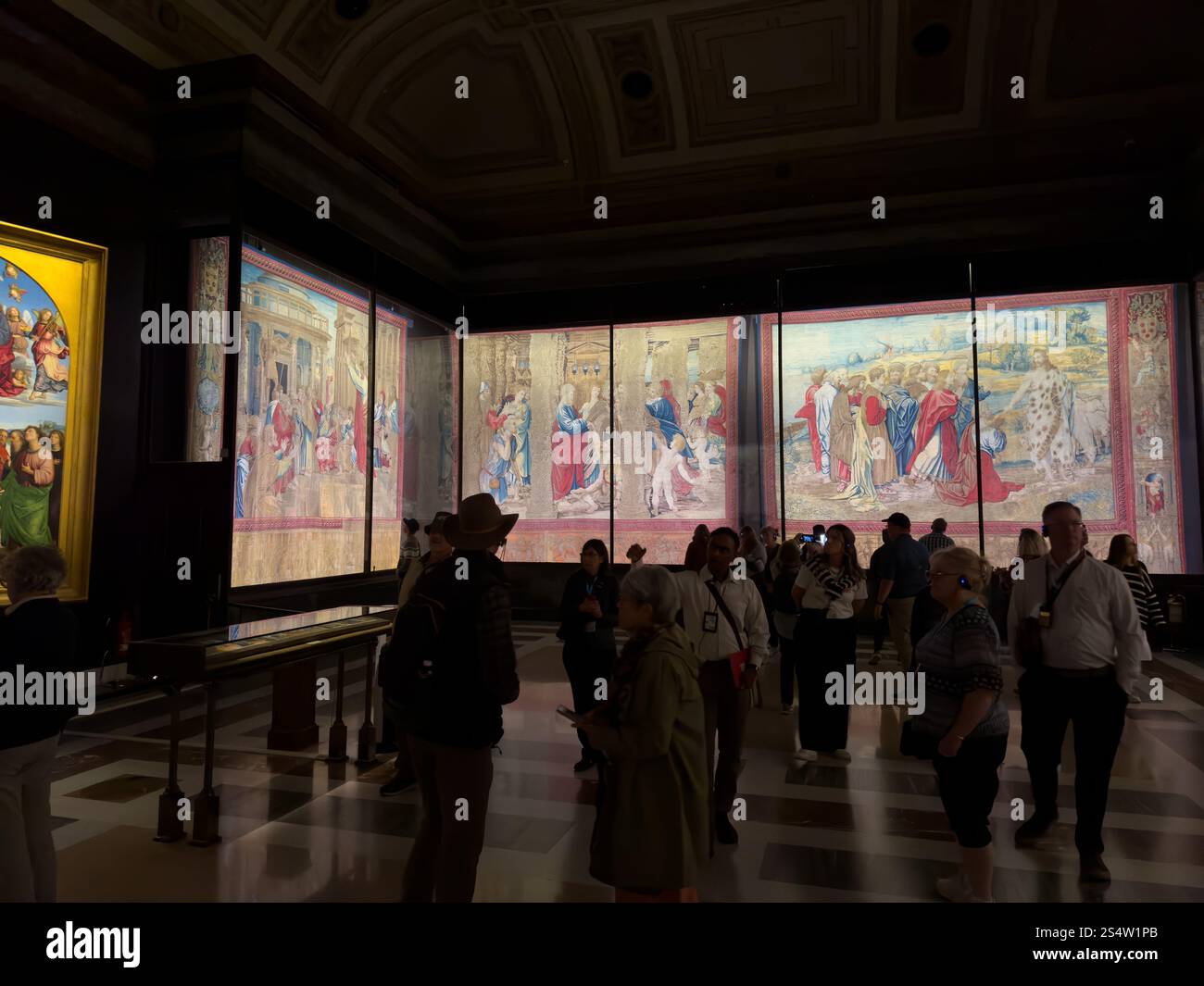Visitors view the Acts of the Apostles tapestries in the Pinacoteca ...