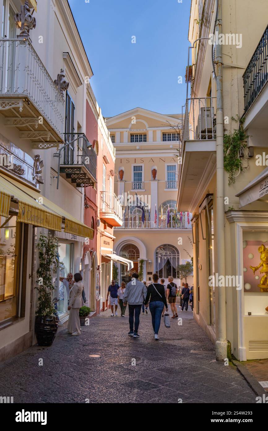 Tourists walk past high-end luxury shops on the Via Vittorio Emmanuele ...