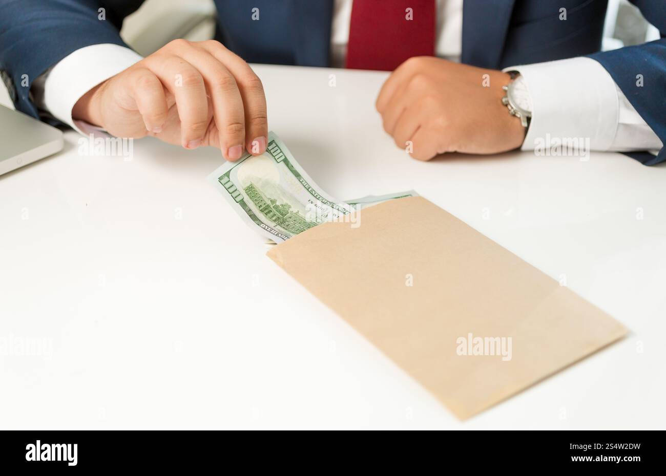 Closeup photo of businessman pulling banknote out of envelope lying on ...