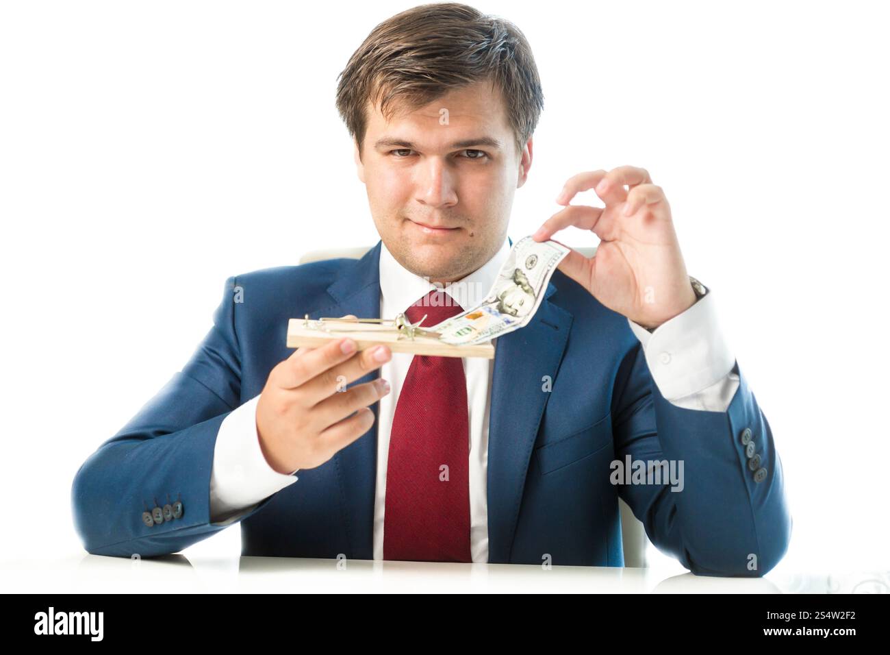 Portrait of cunning businessman taking dollar bill out of mousetrap ...