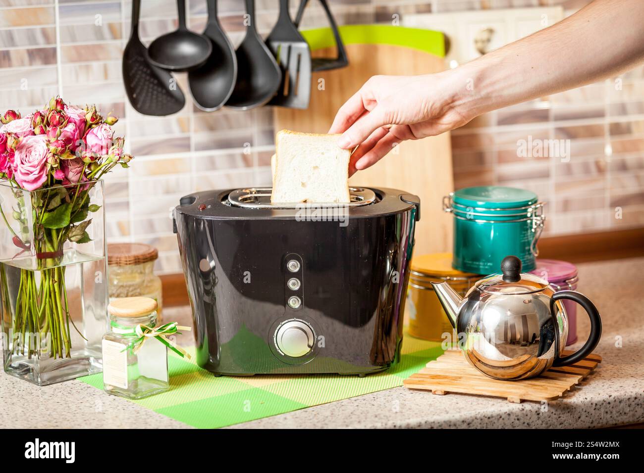 Male hand taking baked toast out of toaster Stock Photo - Alamy