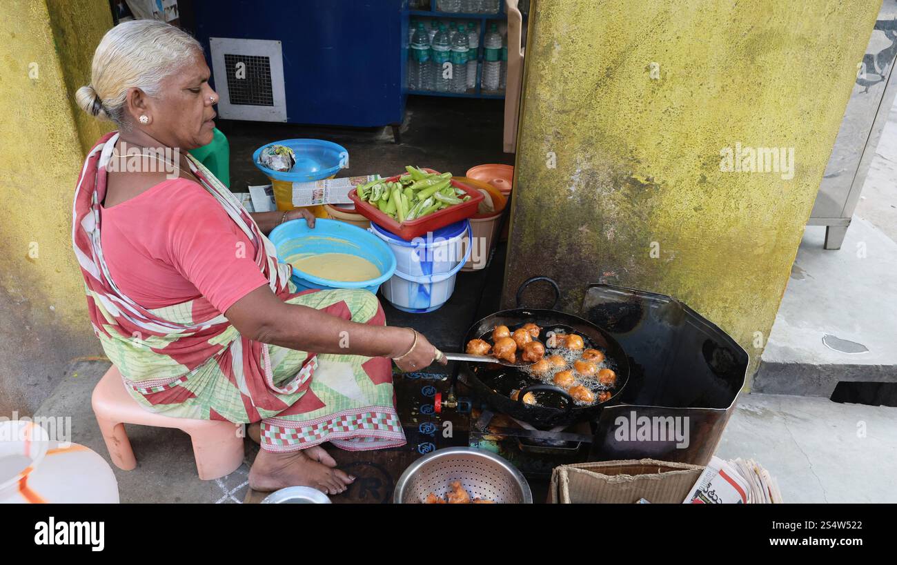 India, Tamil Nadu, Tirupathi, Woman cooking vada in the market Stock ...